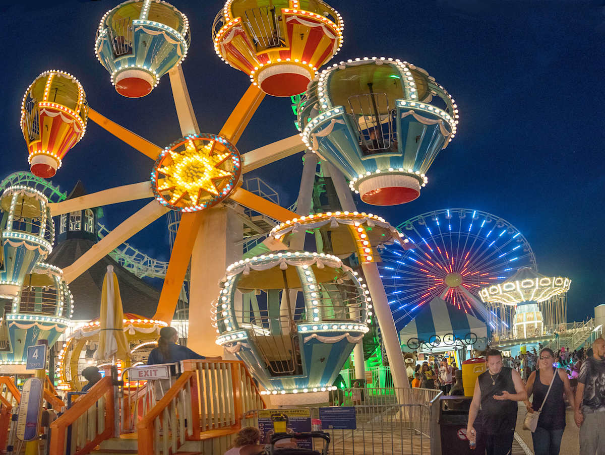 Amusement park rides at night by Alan Powell | Artwork Archive